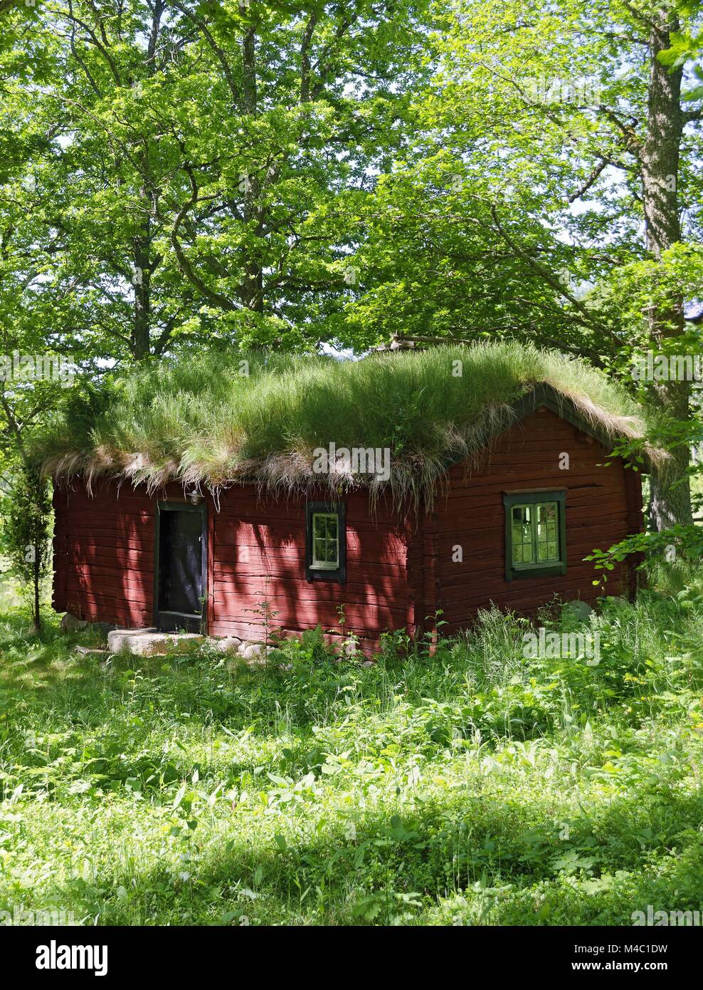red log cabin with grass roof Stock Photo - Alamy