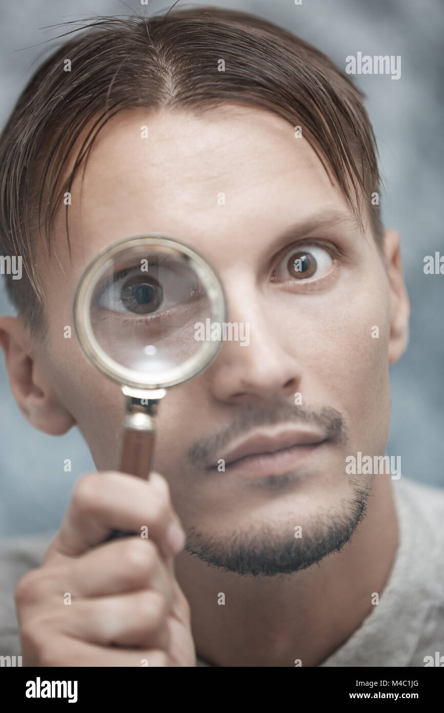 Man with magnifying glass Stock Photo - Alamy