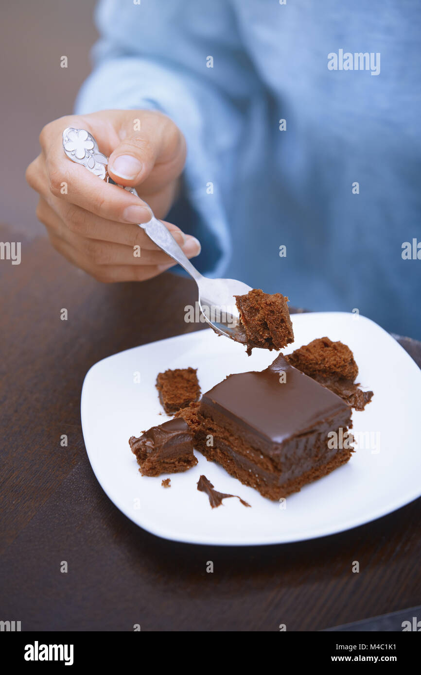 Woman eating chocolate cake Stock Photo - Alamy