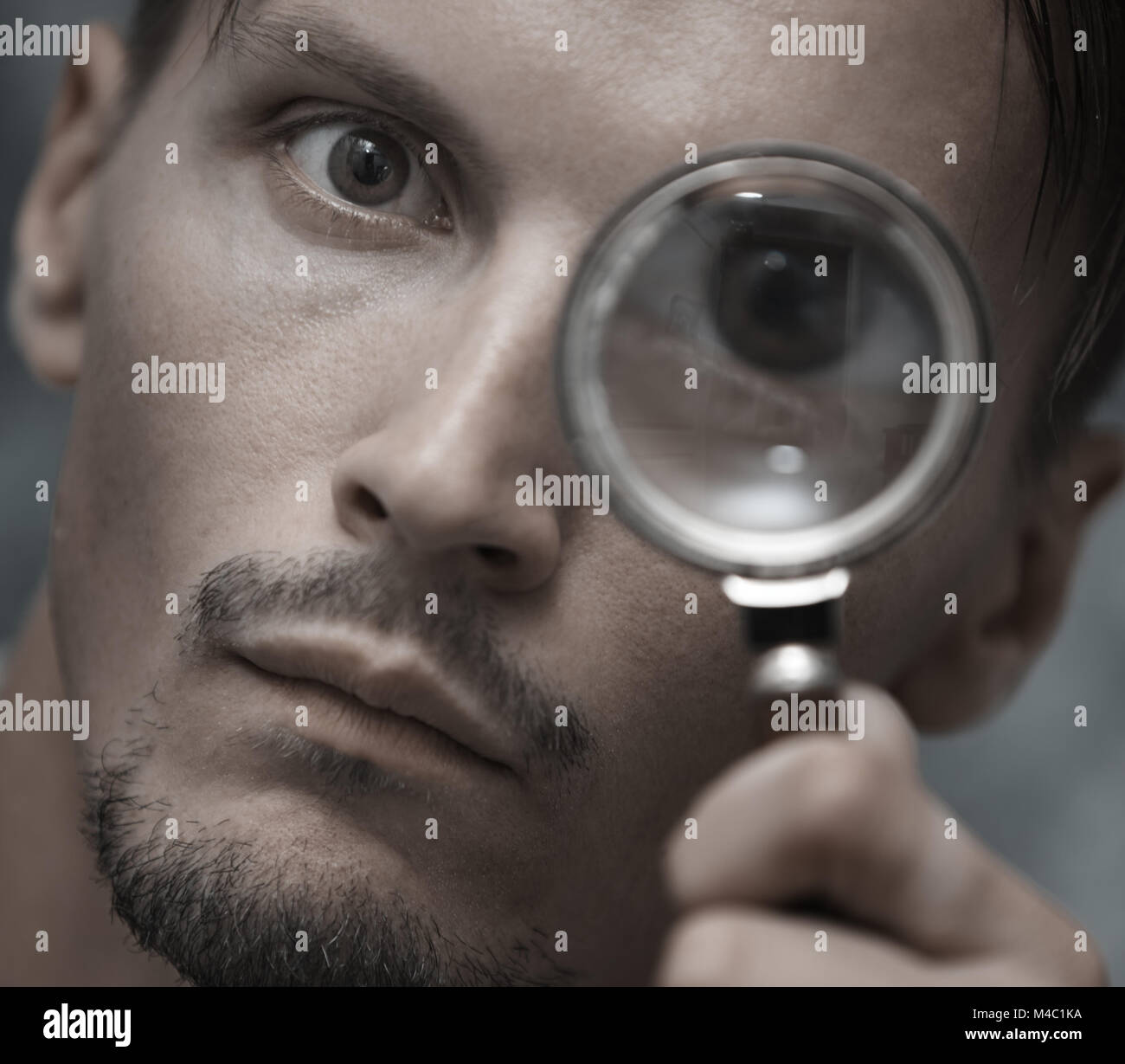 Man with magnifying glass Stock Photo - Alamy