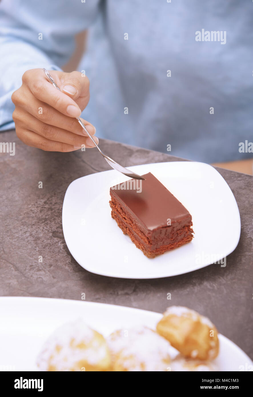 Woman eating chocolate cake Stock Photo - Alamy