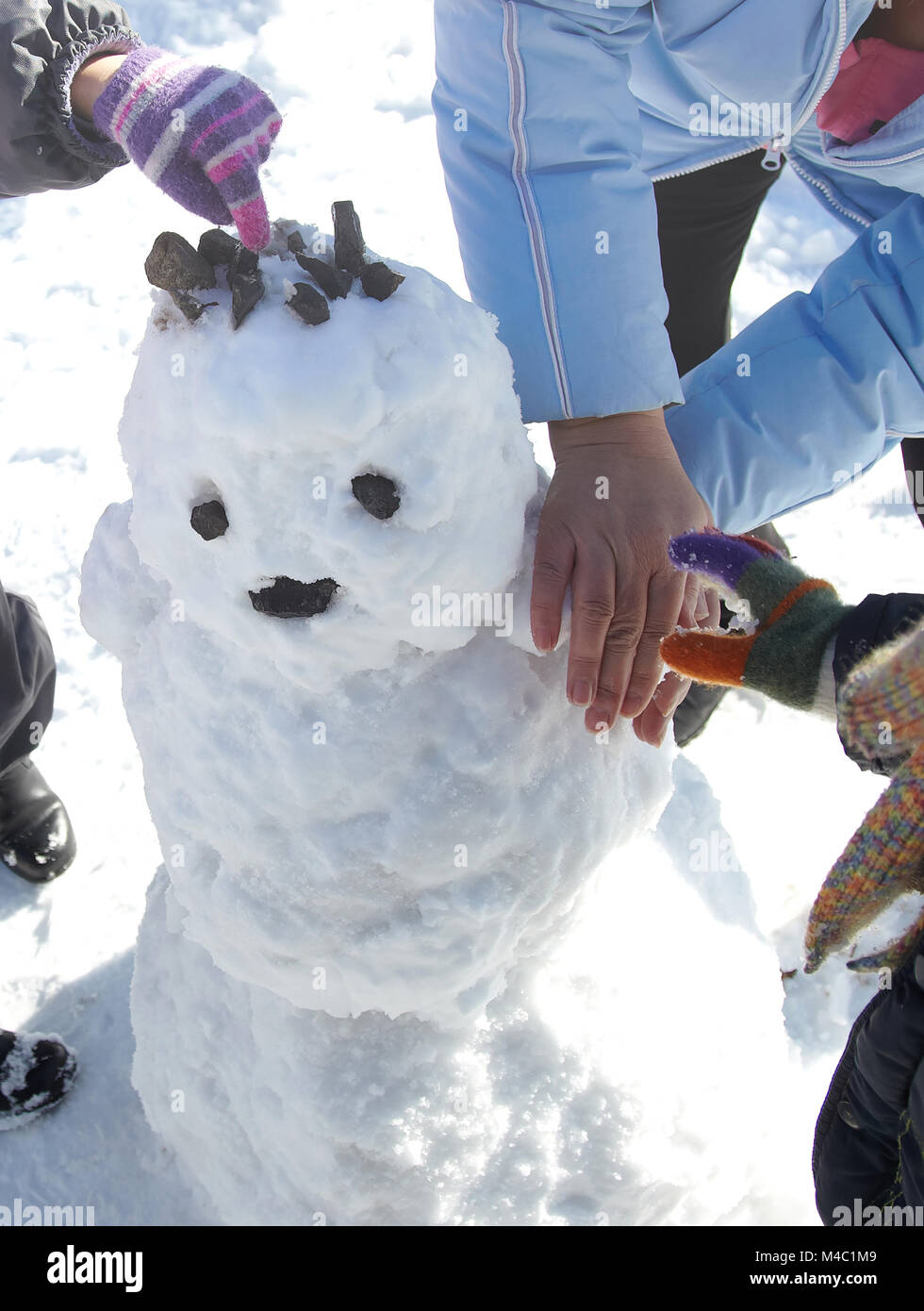 People making snowman Stock Photo - Alamy