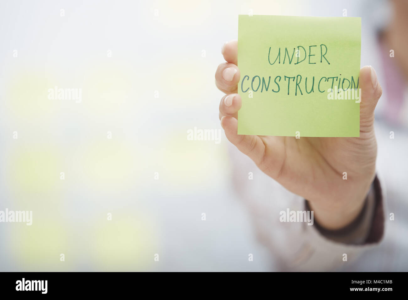 Under construction text on adhesive note Stock Photo - Alamy