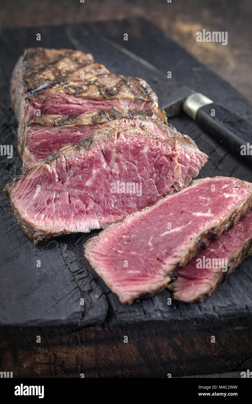 Barbecue Aged Roast Beef on burnt Wooden Board Stock Photo - Alamy