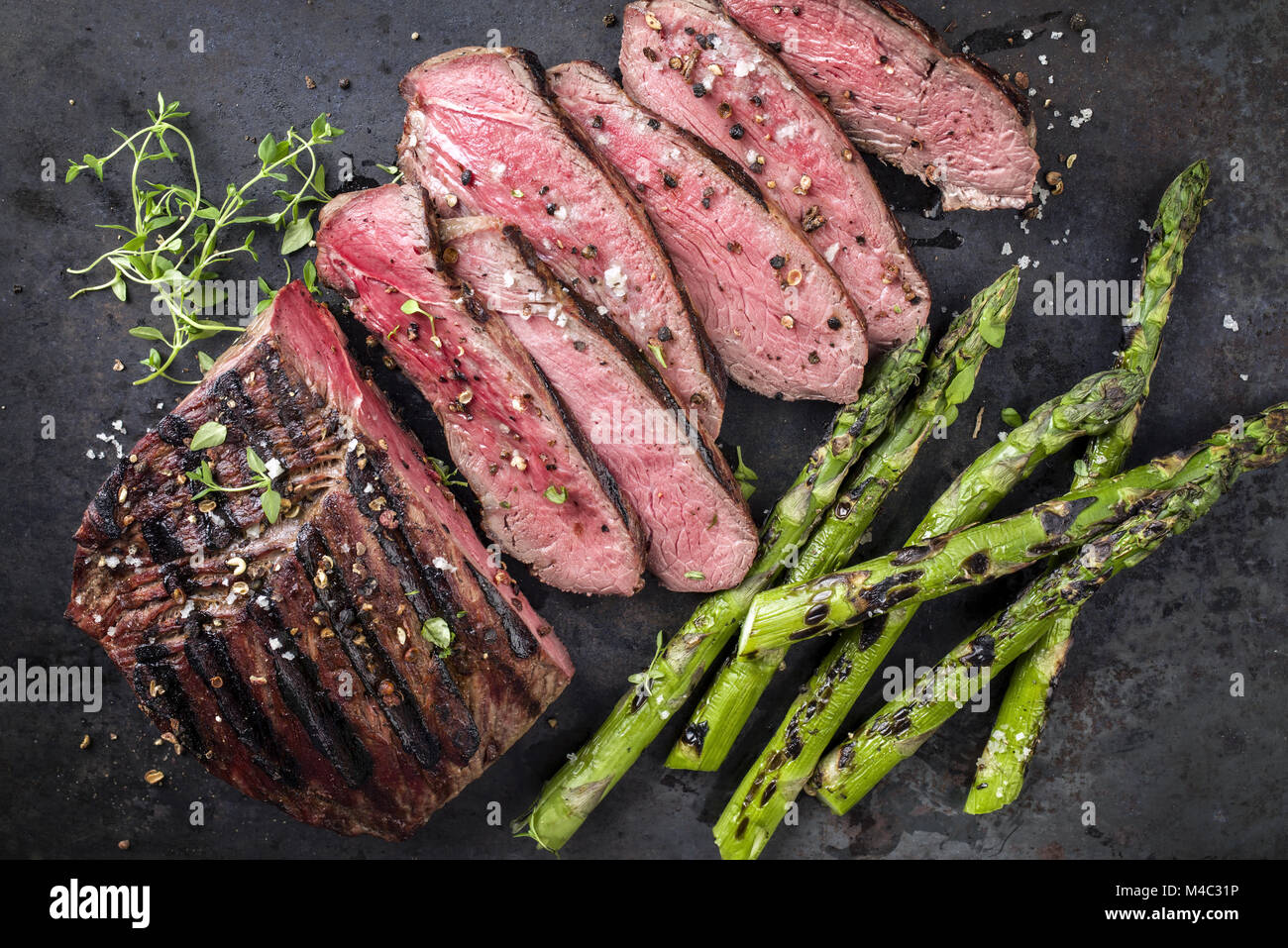 Barbecue Point Steak with Green Asparagus on old Sheet Stock Photo - Alamy