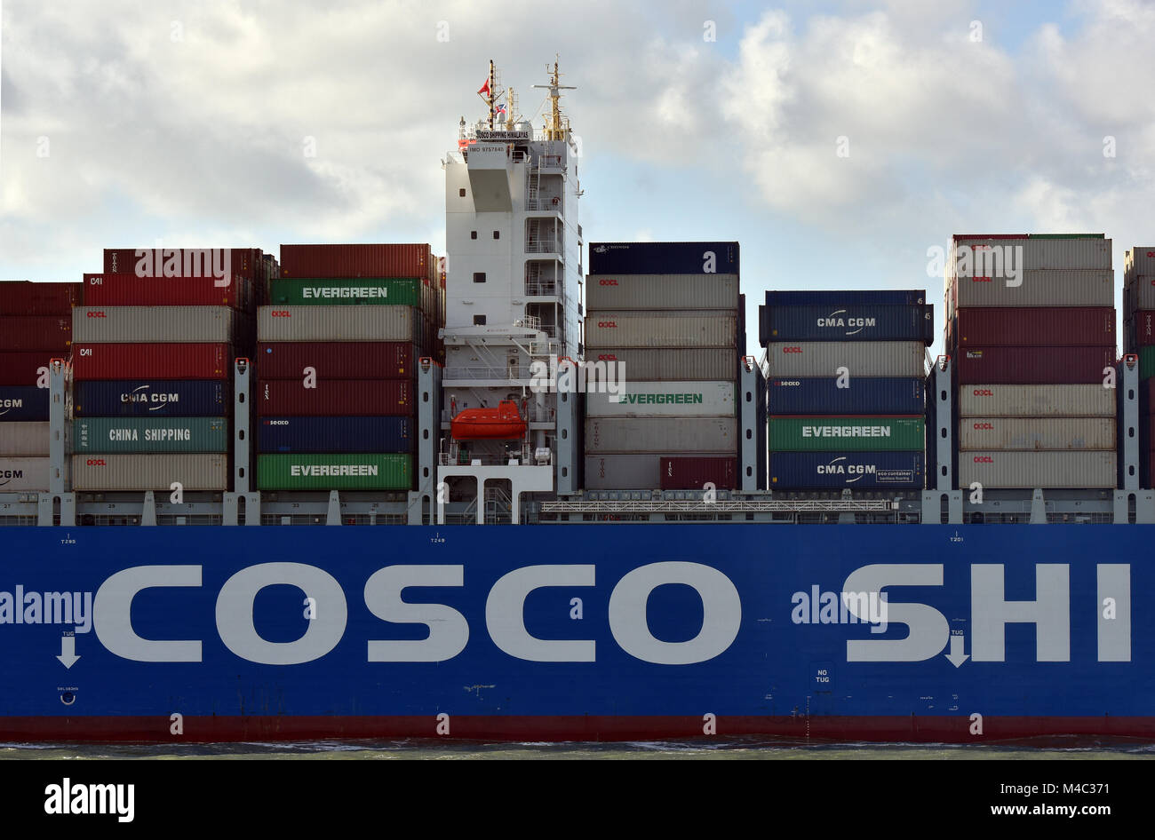 a massive or huge container ship entering or leaving the port of ...