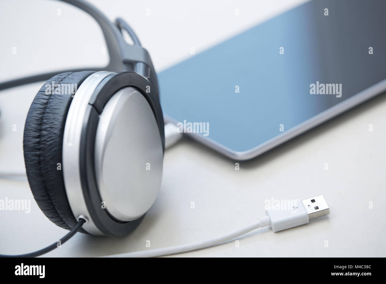 Headphones and tablet computer on a table Stock Photo - Alamy