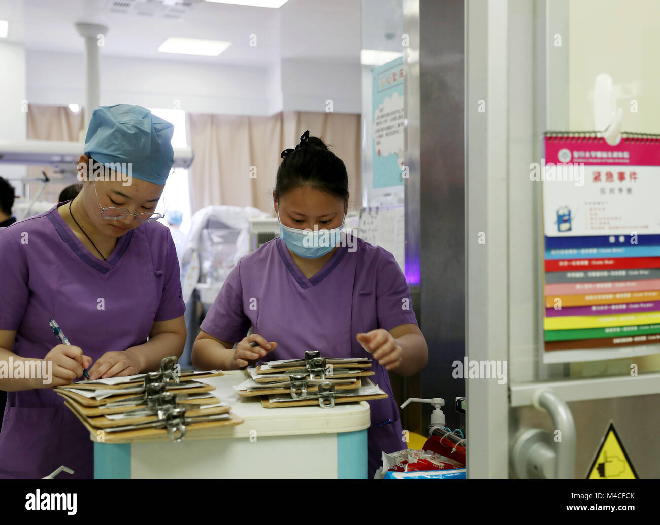 Shanghai, China. 15th Feb, 2018. Nurses fill in a nursing journal at ...
