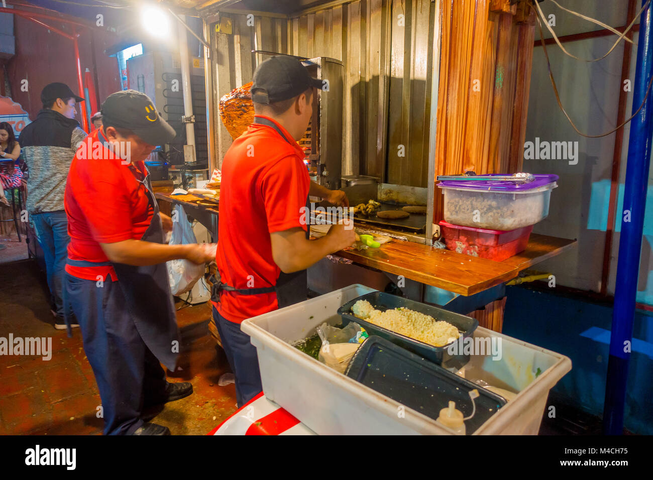 CANCUN, MEXICO - JANUARY 10, 2018: Indoor view with two men cooking ...
