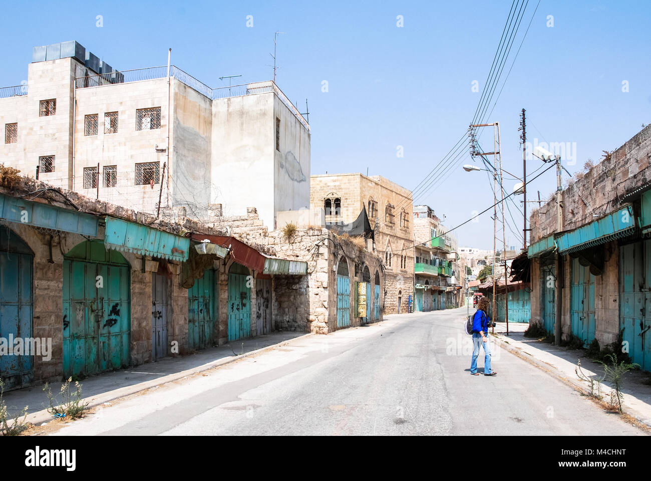 Horizontal picture of woman photographer walking in the streets of ...