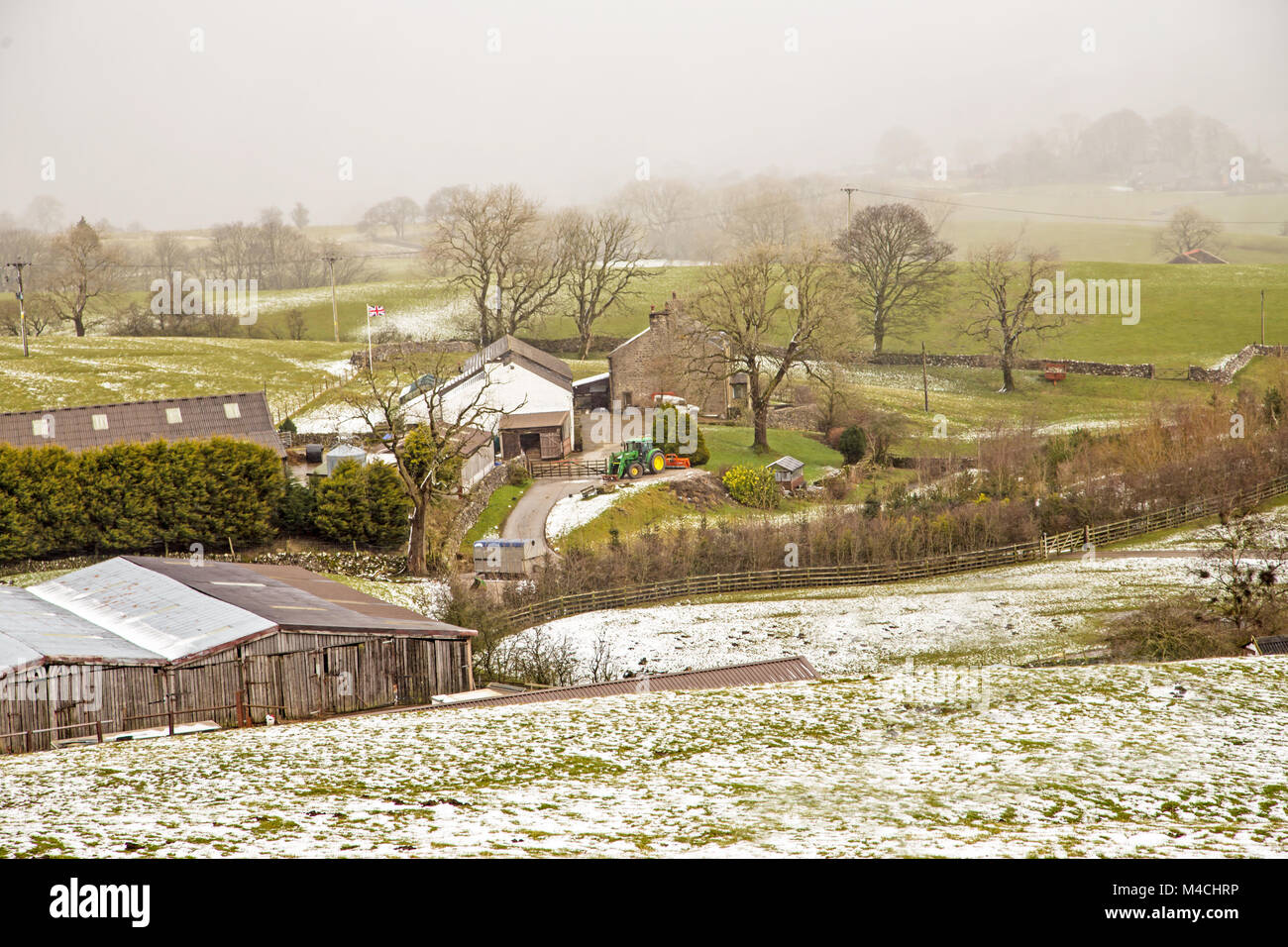 A snowy dales farm with snow shoers behind Stock Photo - Alamy
