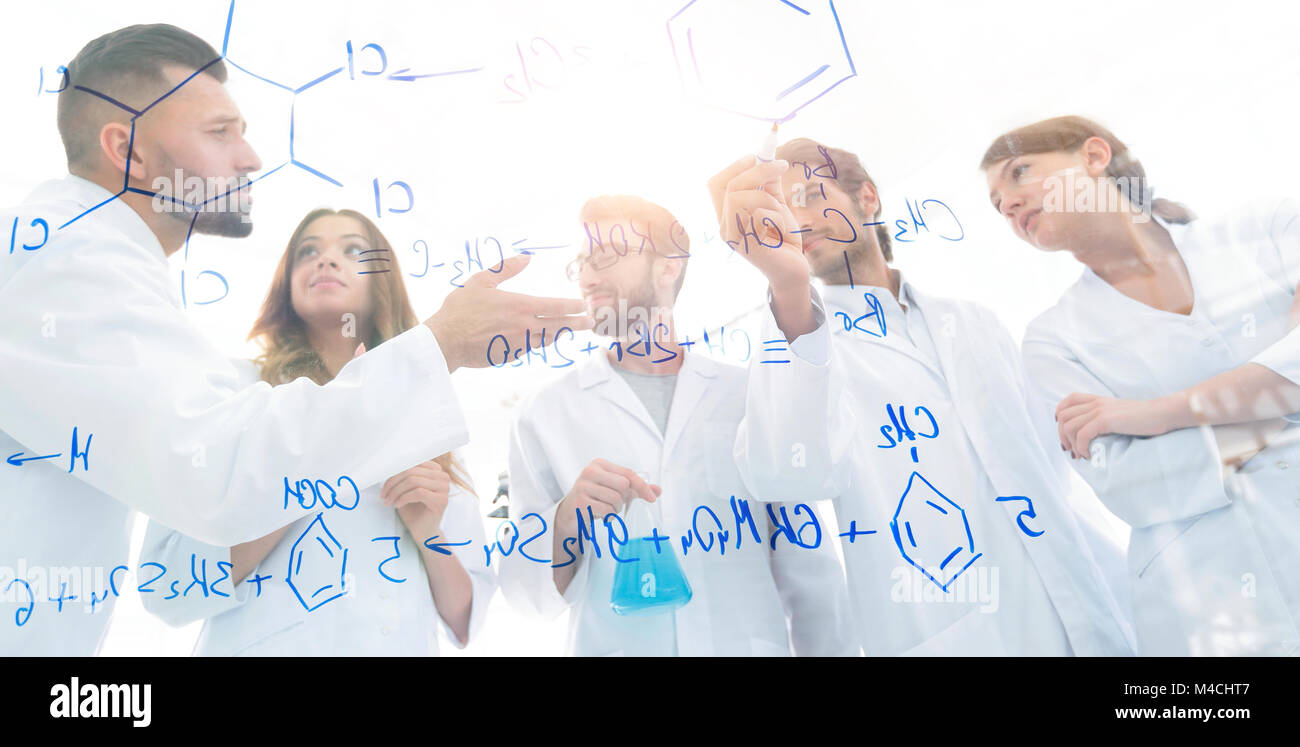 view through the transparent Board. a group of scientists analyze ...