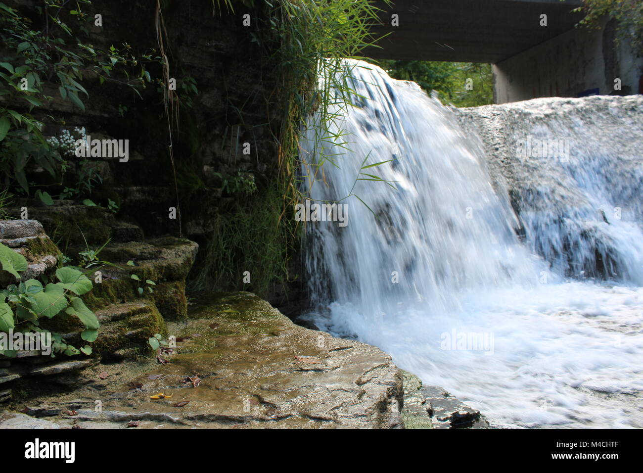 A hidden waterfall/ lagoon along a creek Stock Photo - Alamy