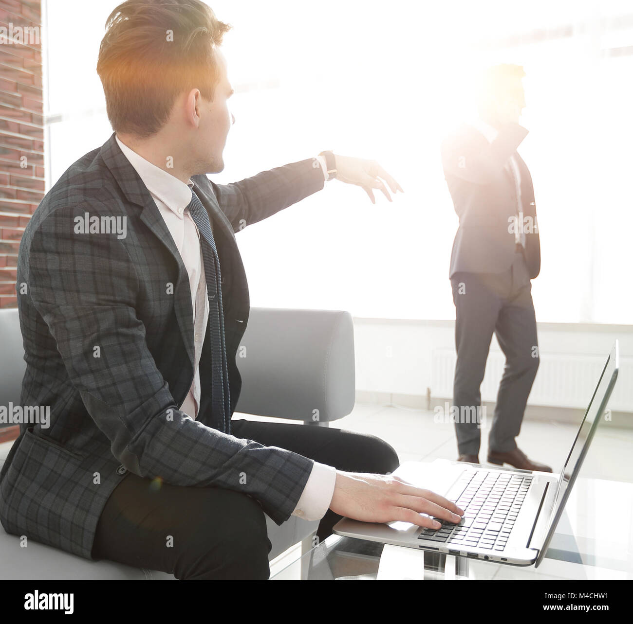 businessman with laptop pointing at the screen Stock Photo - Alamy