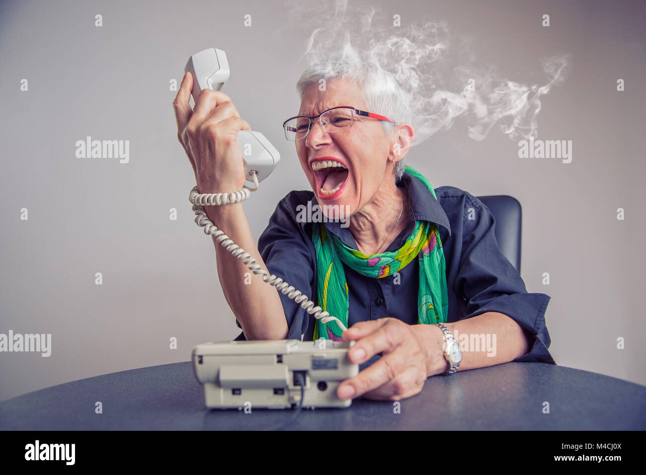 Terrible service, angry senior woman yelling at phone Stock Photo - Alamy