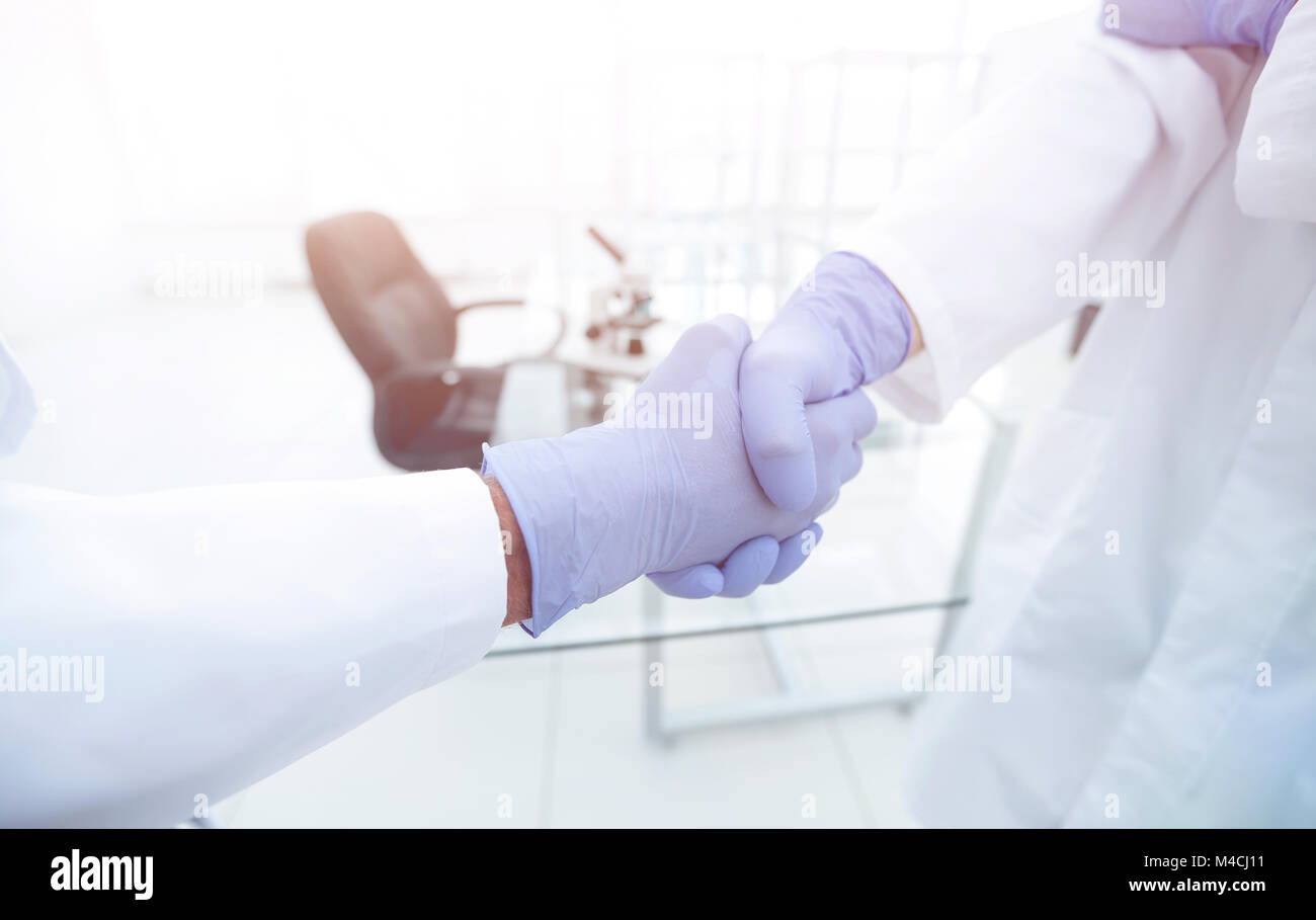 hand in the medical glove (handshake Stock Photo - Alamy