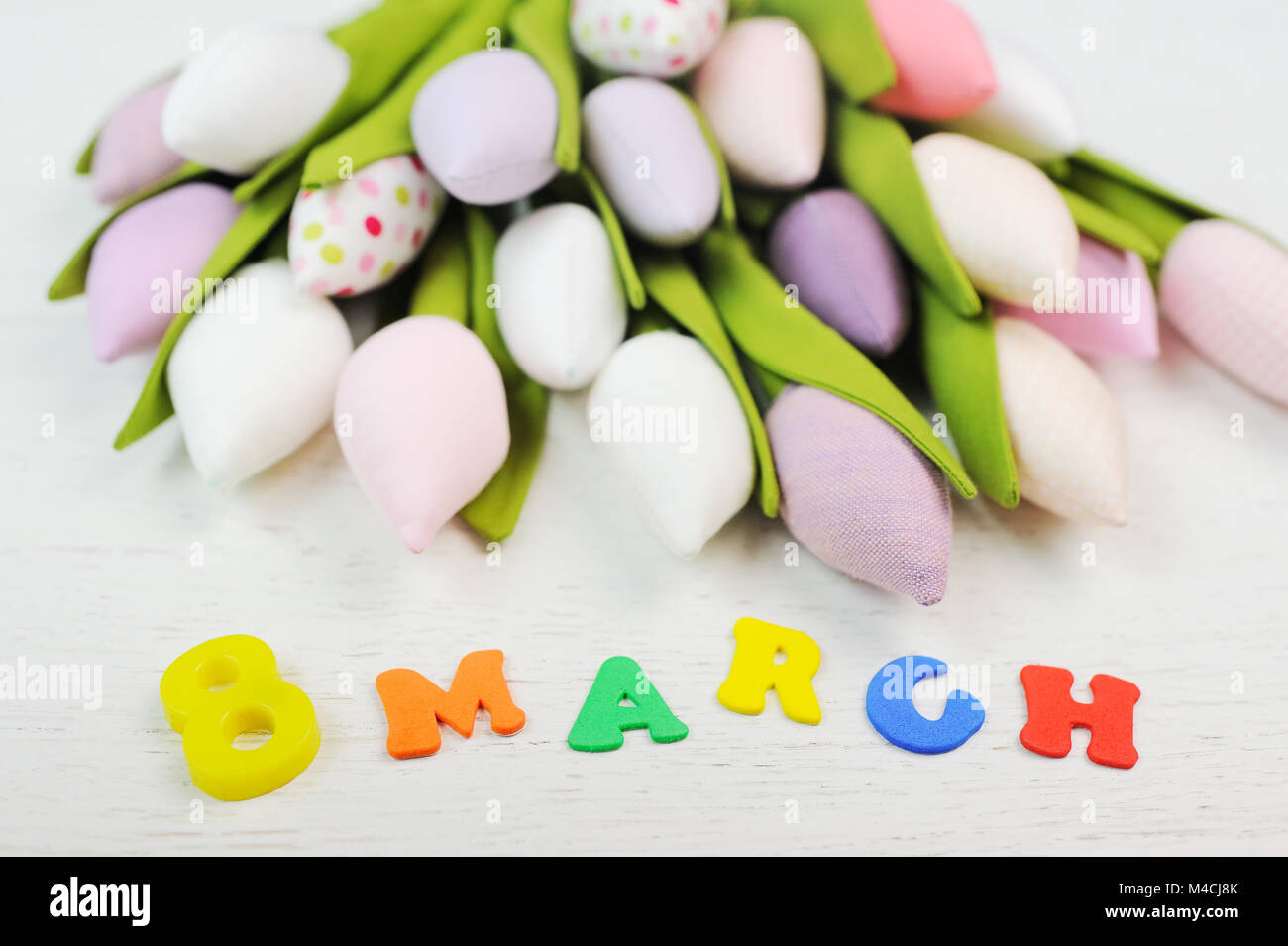 inscription from color letters - March 8 against a background of toy ...