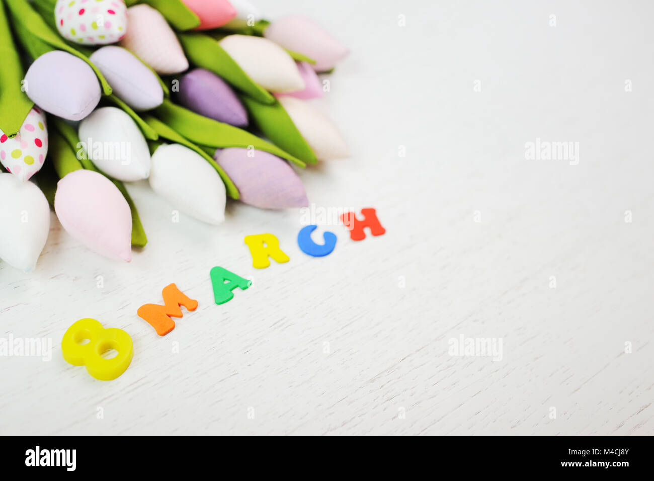 inscription from color letters - March 8 against a background of toy ...