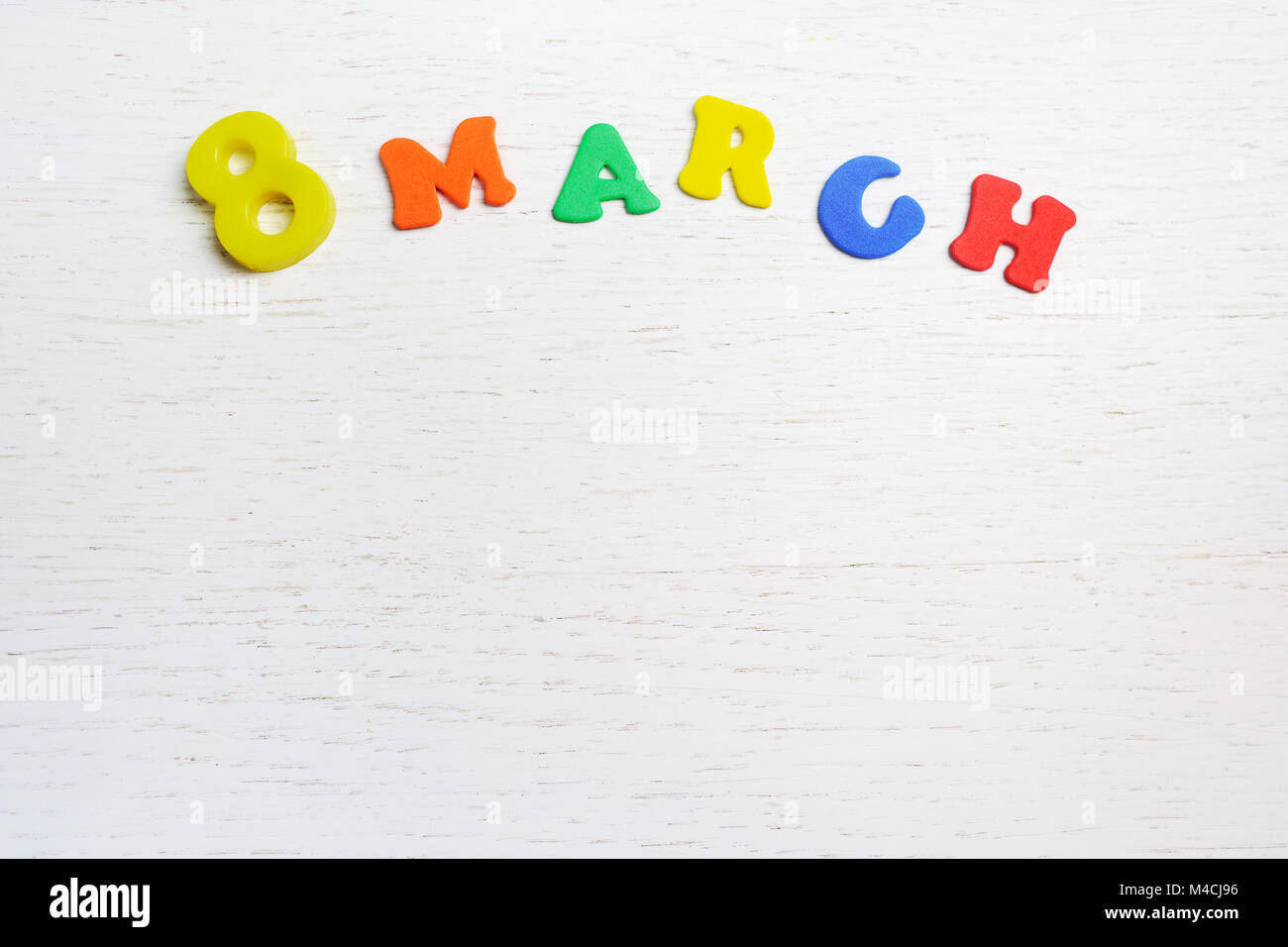 inscription on March 8 from colored letters on a white wooden ...