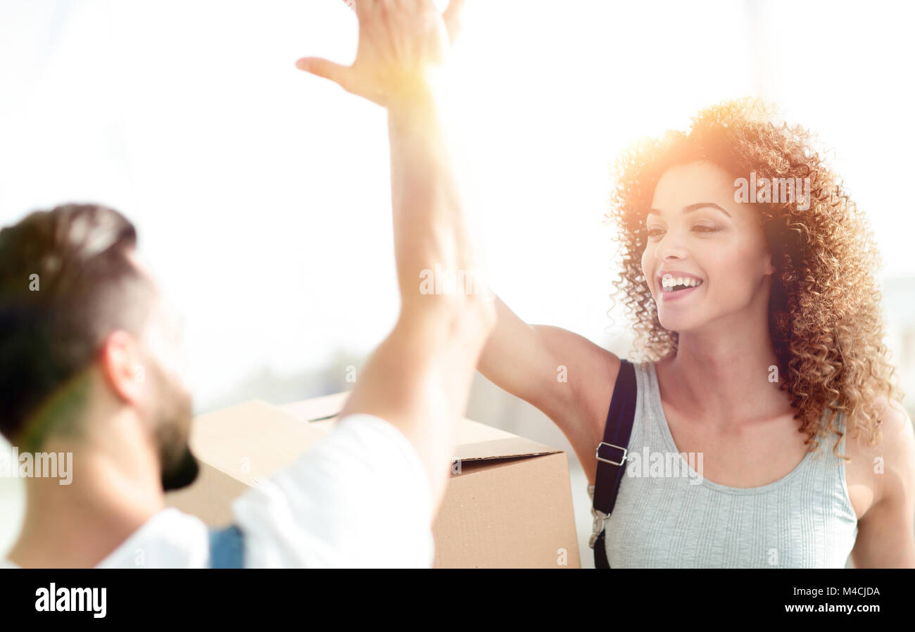 Happy and young couple giving a high five Stock Photo - Alamy