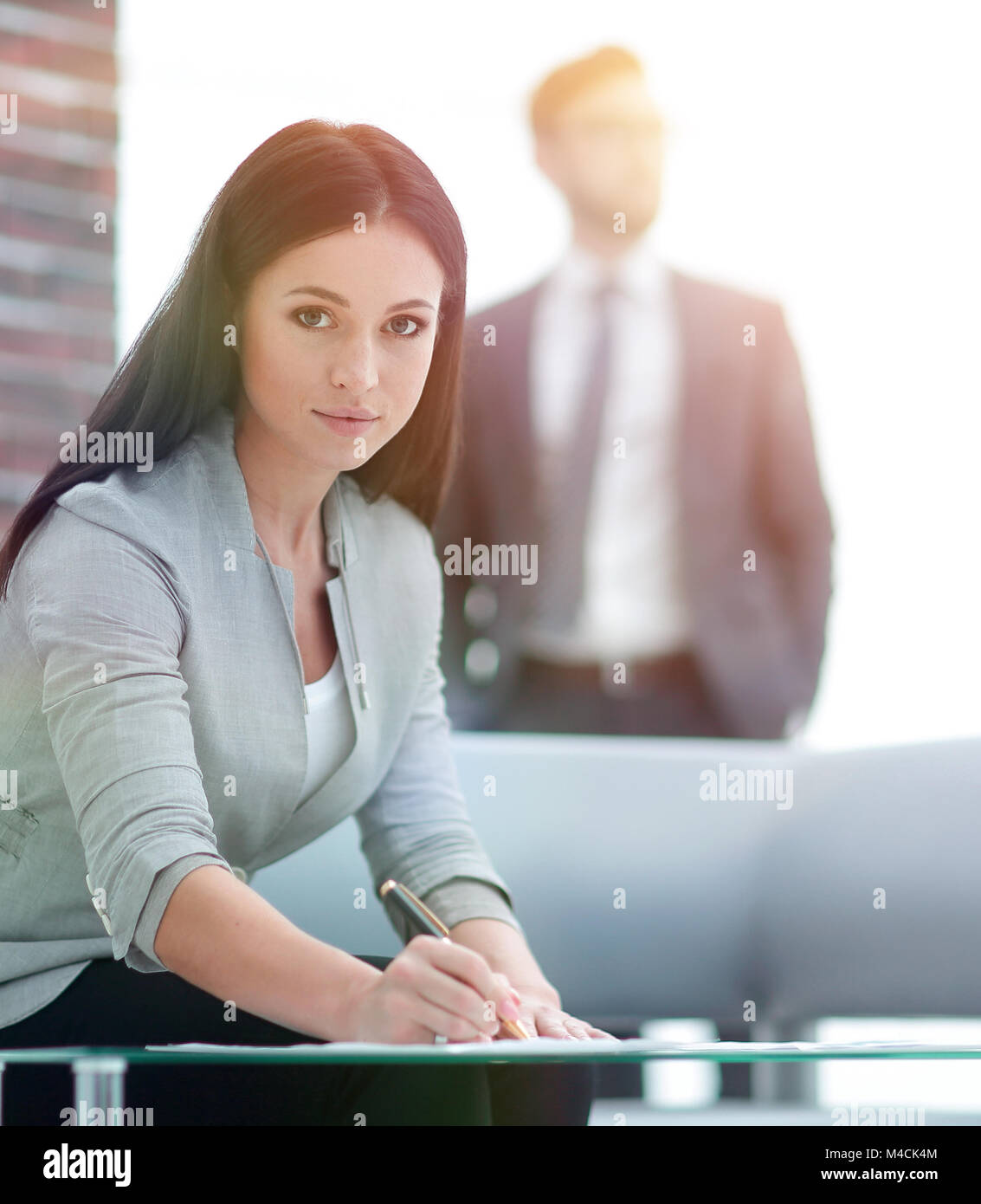 business woman signs documents in a modern office Stock Photo - Alamy