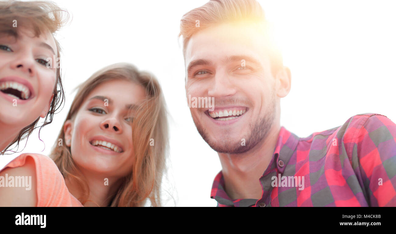closeup of three young people smiling on white background Stock Photo ...