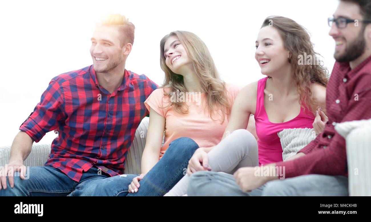 group of cheerful friends sitting on the couch Stock Photo - Alamy