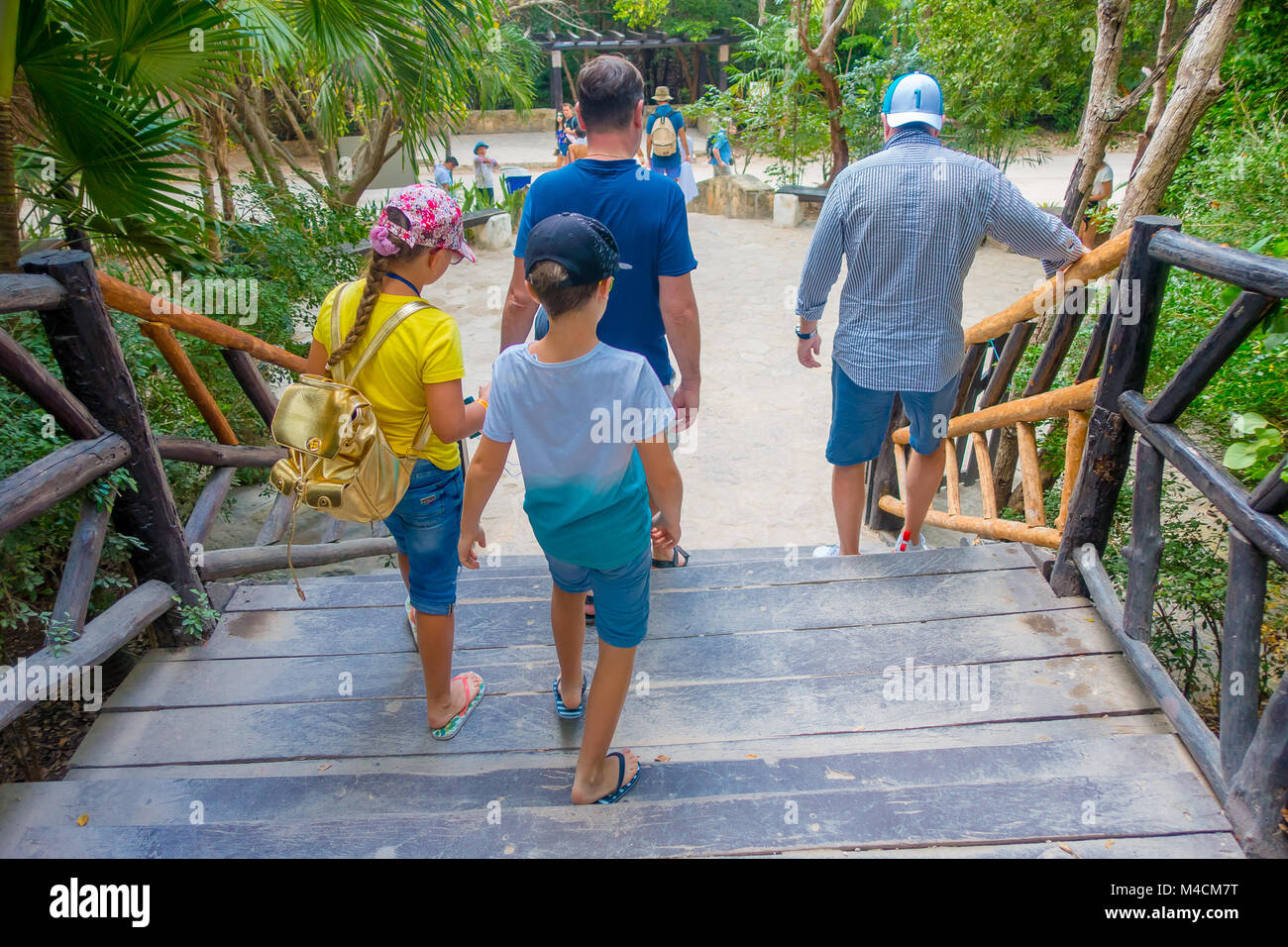 TULUM, MEXICO - JANUARY 10, 2018: Unidentified people walking over a ...