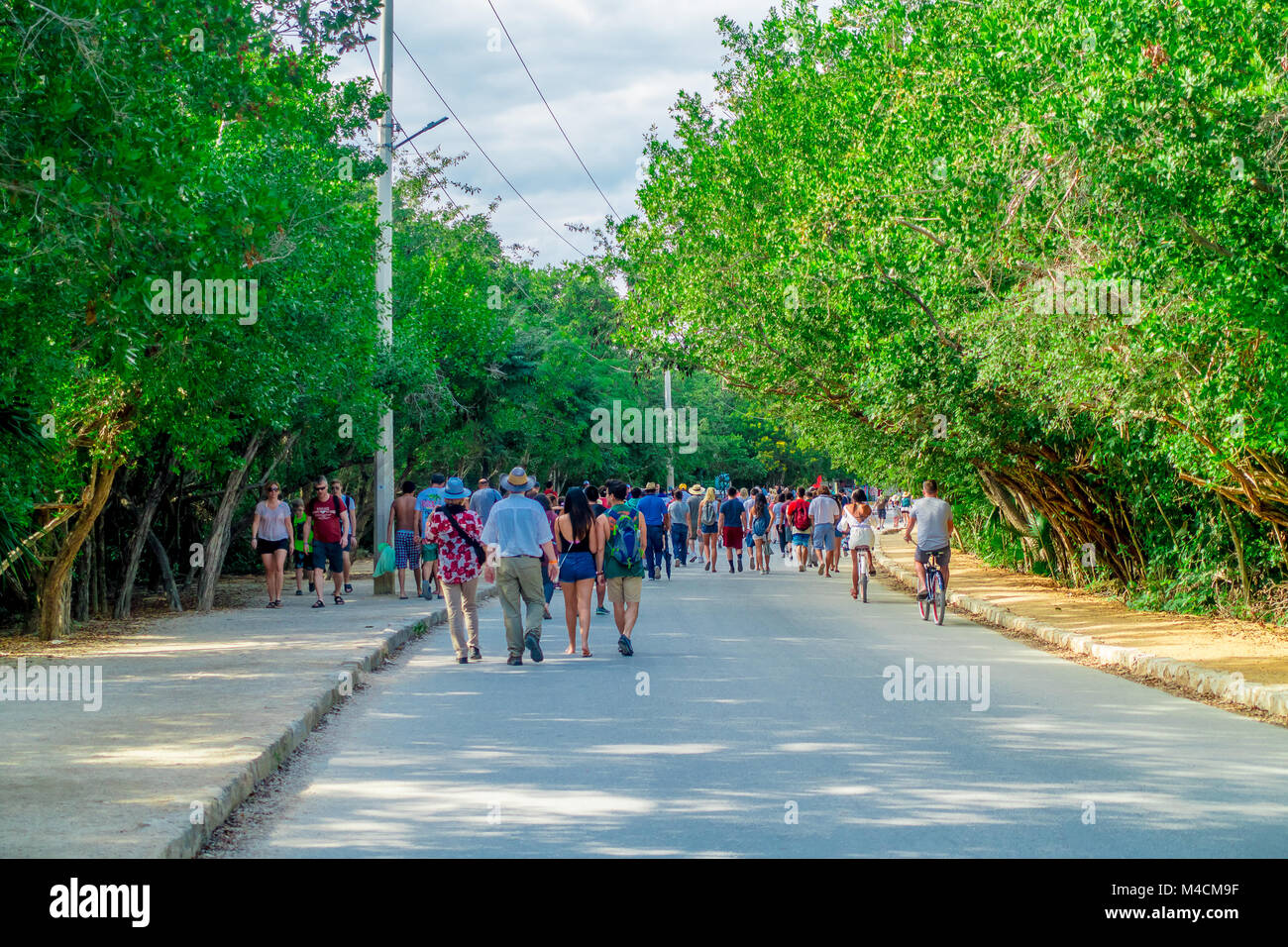 TULUM, MEXICO - JANUARY 10, 2018: Crowd of people walking in an ...