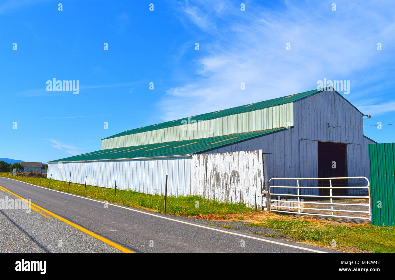 White barn with green roof along a country road in the pacific ...