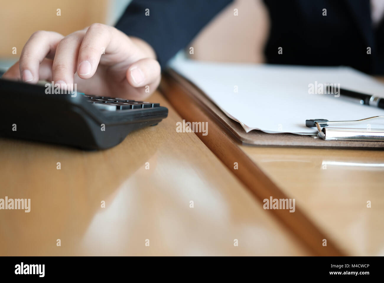 financial adviser working with calculator, business document & computer ...