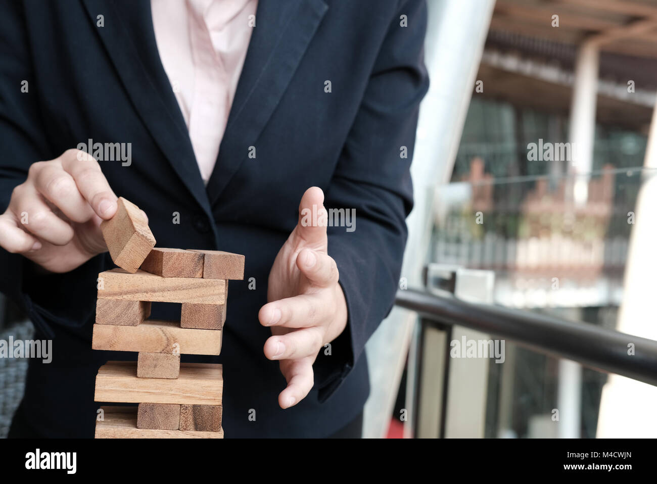 Hand choosing wooden block hi-res stock photography and images - Alamy