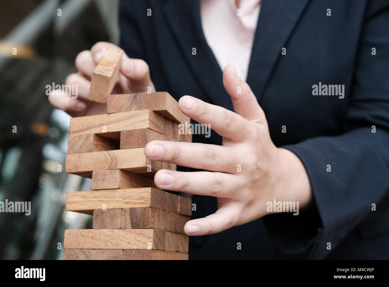Hand choosing wooden block hi-res stock photography and images - Alamy