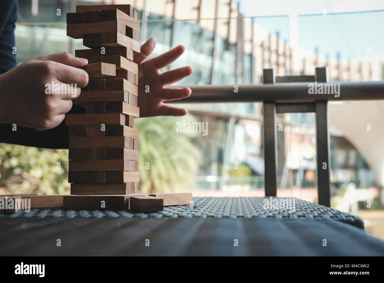 businesswoman hand pull out wood block from tower. growth, risk ...
