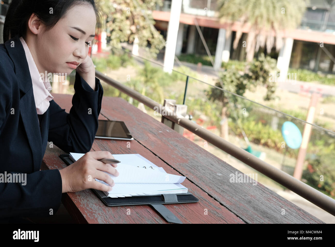 bored businesswoman lean head on hand outside office building. unhappy ...