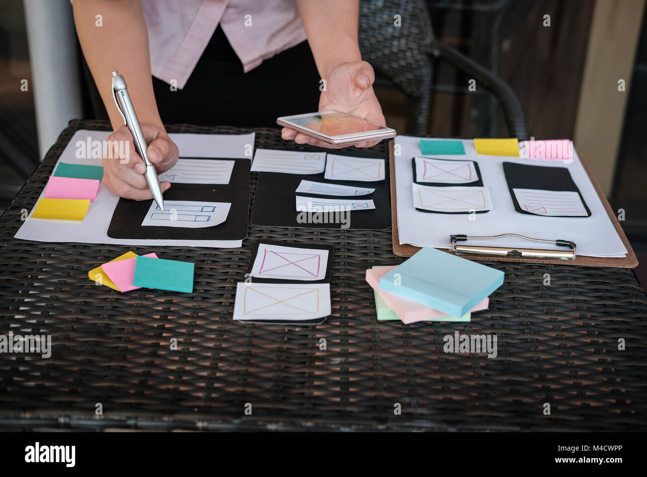 user experience (UX) designer designing web on smart phone layout. UI ...