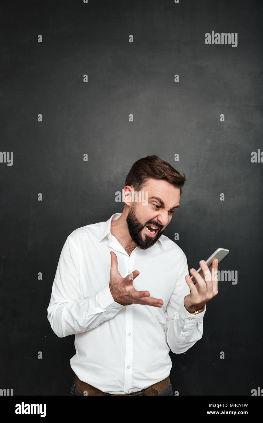 Studio photo of angry man yelling being irritated while looking on ...