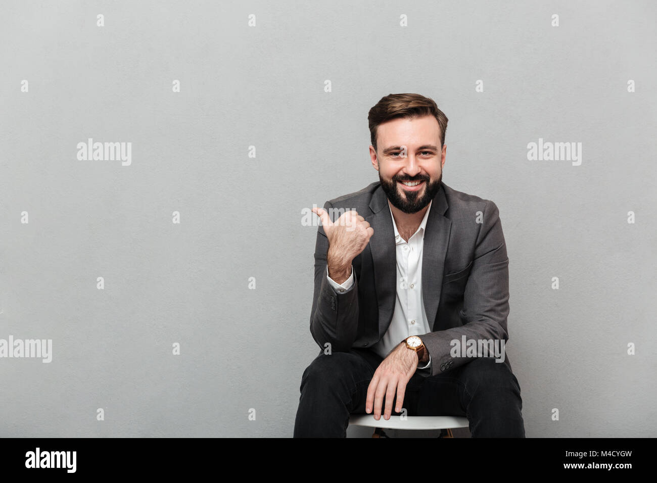 Cropped portrait of joyful man resting on chair in office and gesturing ...