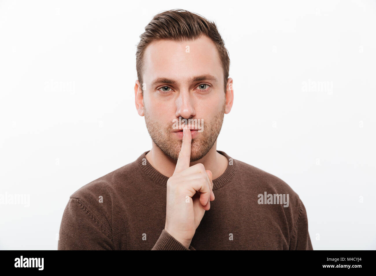 Image of handsome young serious man standing isolated over white ...