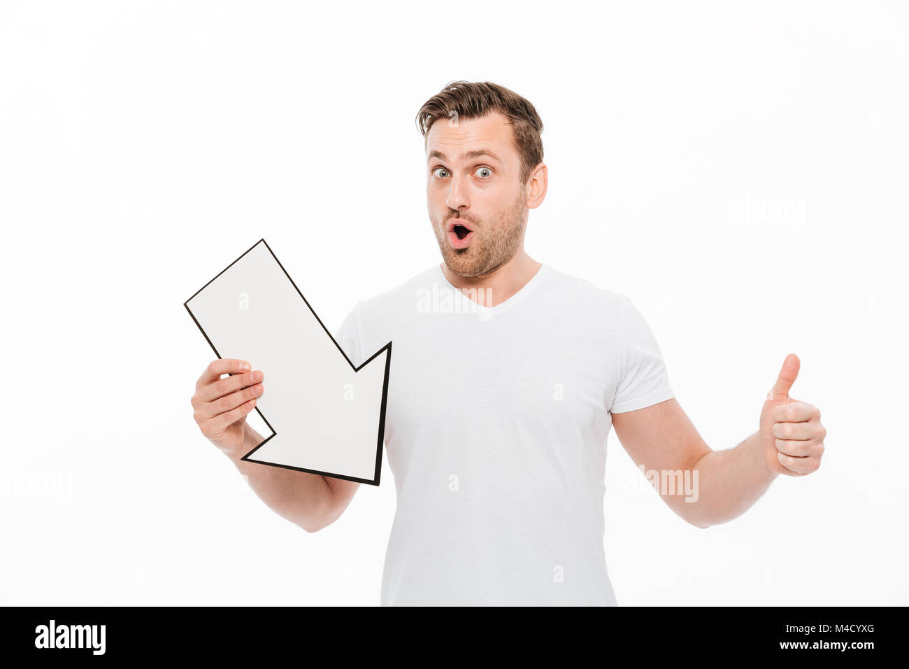 Photo of emotional shocked young man standing isolated over white ...