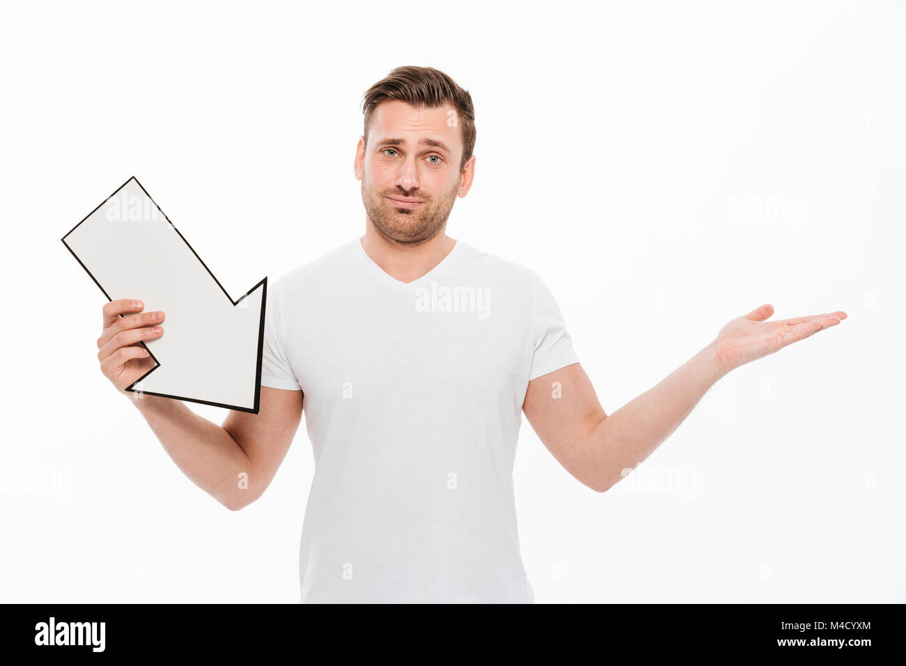 Picture of confused young man standing isolated over white background ...