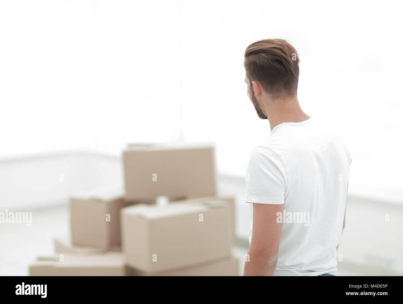 rear view.a young man in the new apartment Stock Photo - Alamy