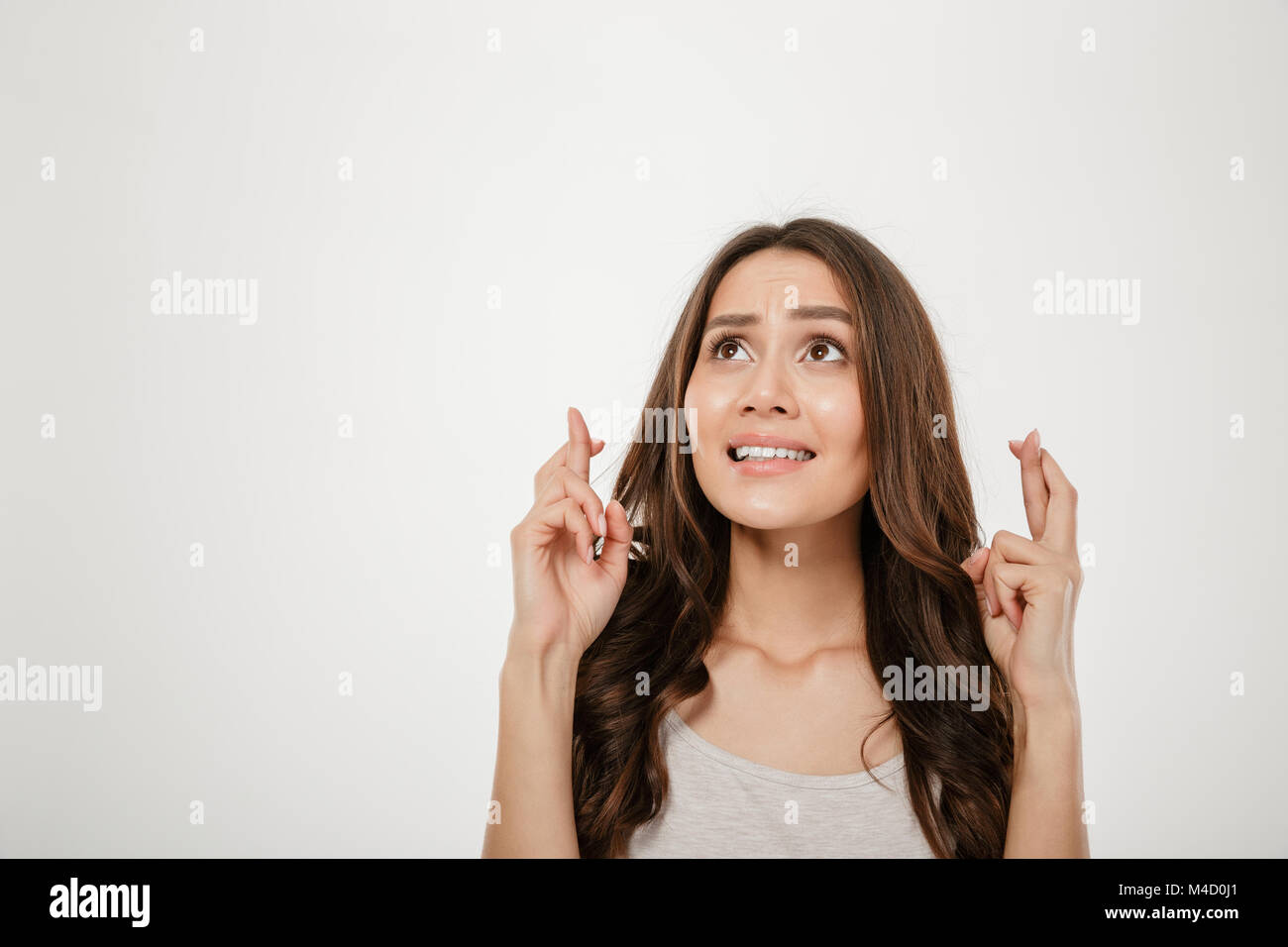 Portrait of praying young woman wearing casual begging god please ...