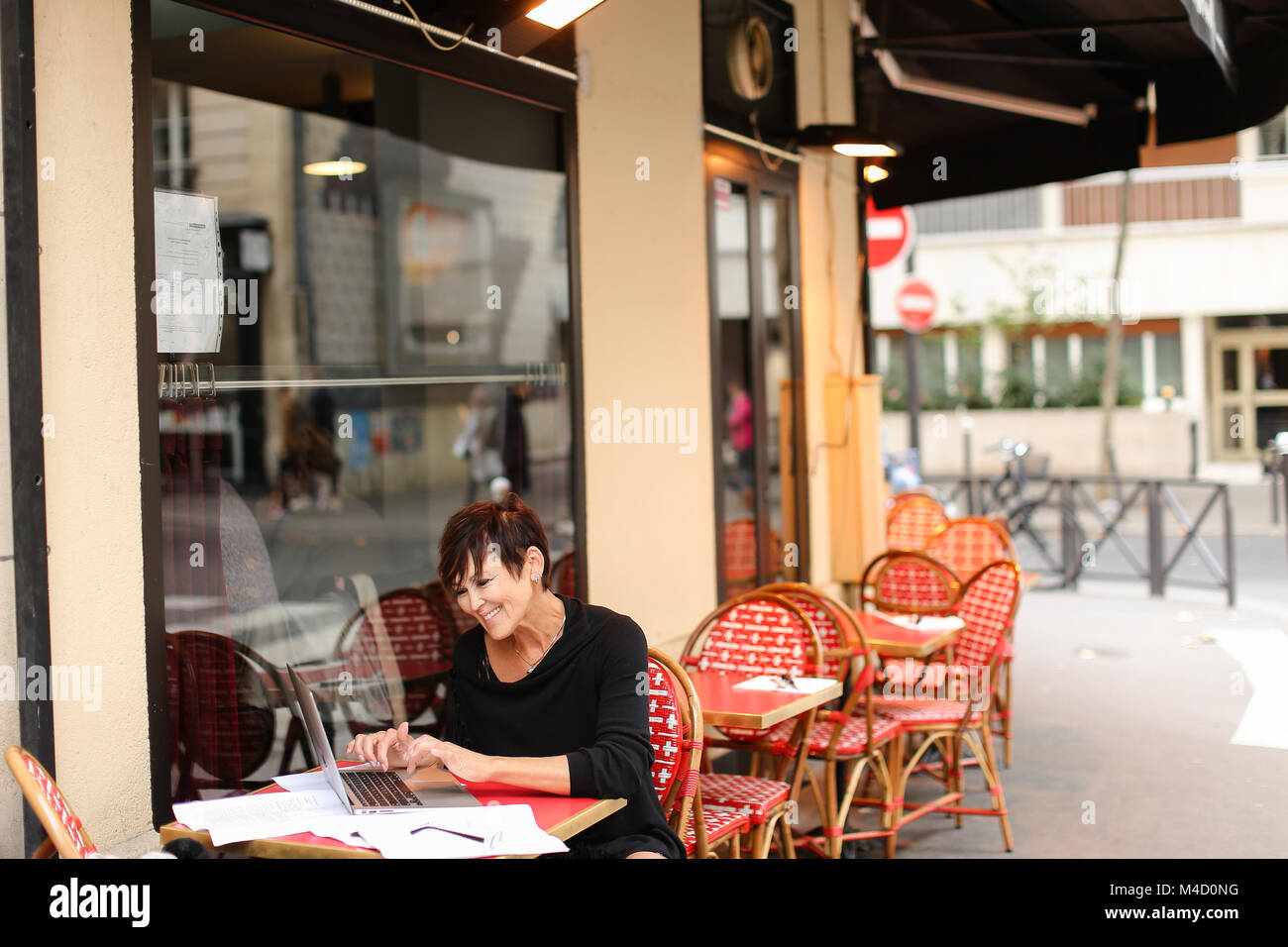 aged female screenwriter working with scenario in laptop Stock Photo ...