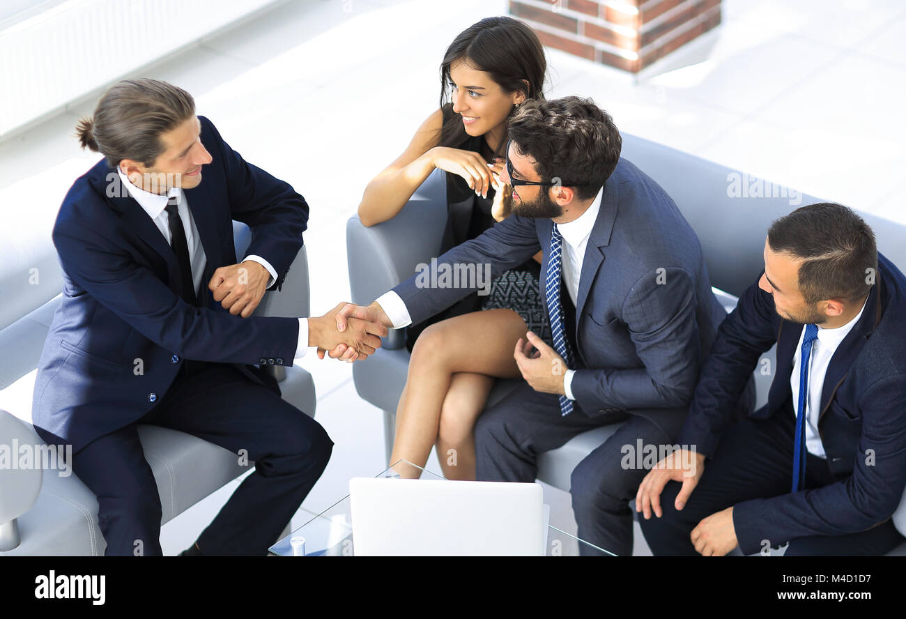 handshake Manager and the client sitting in the office lobby Stock ...