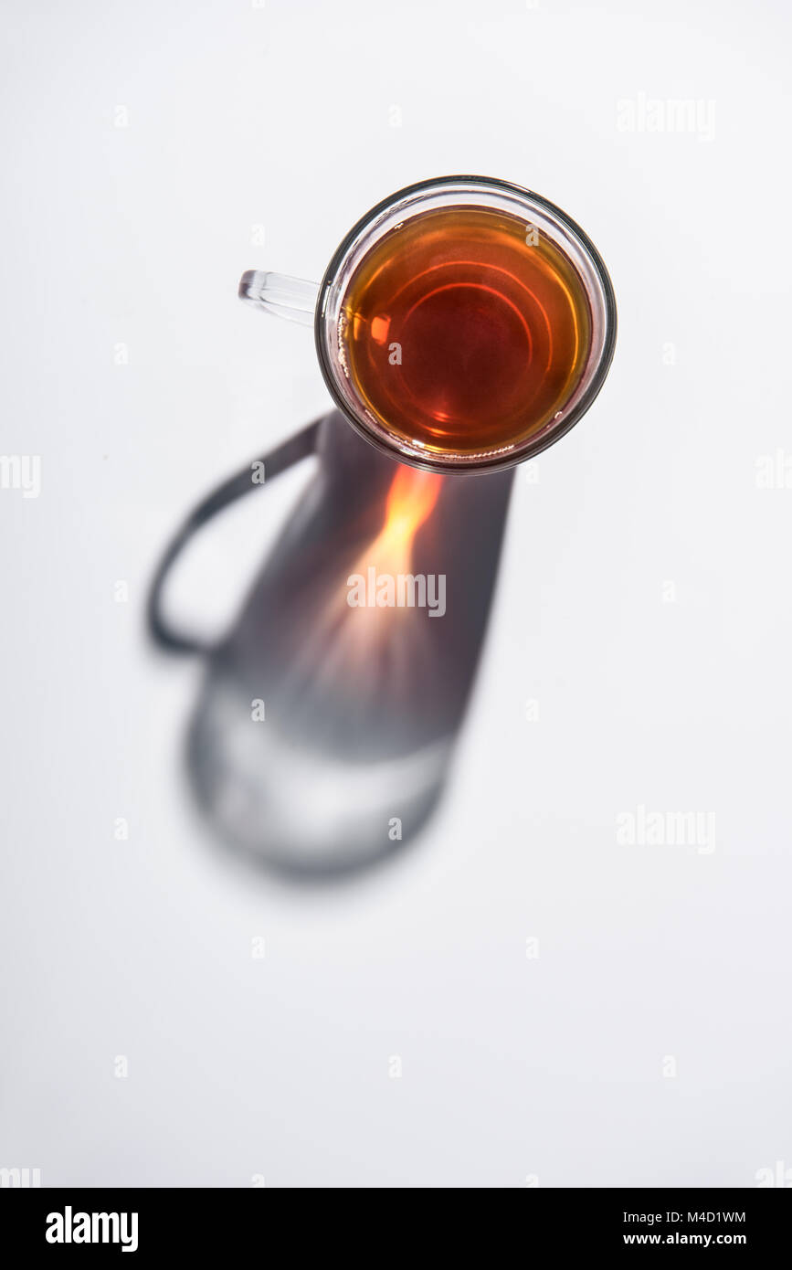 top view of glass cup with black tea on white table Stock Photo - Alamy