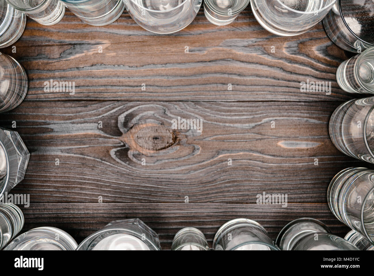 top view of frame with glasses of water on wooden table Stock Photo - Alamy