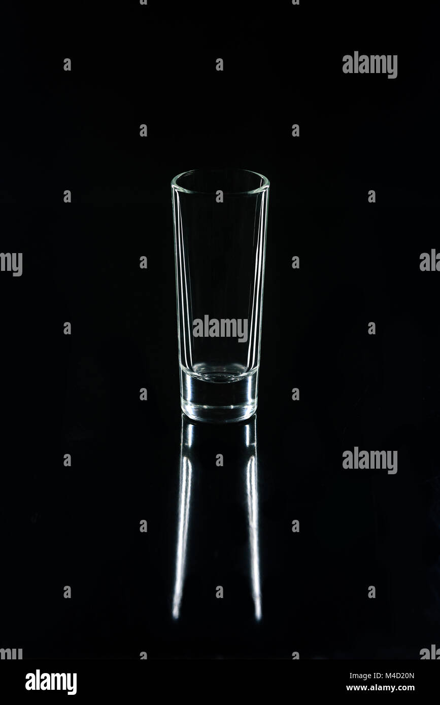one small glass on black reflecting surface Stock Photo - Alamy