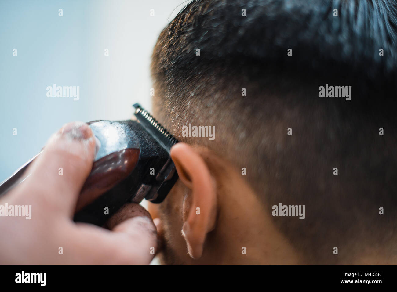 Getting perfect shape. Close-up side view of young bearded man getting ...