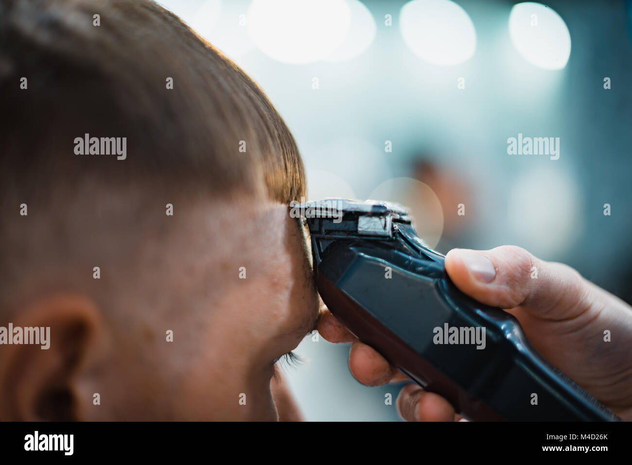 Professional barber makes hairstyle electric hi-res stock photography ...